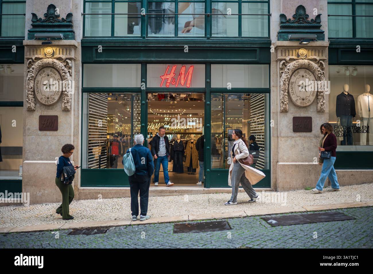 People walking by H&M flagship store in Chiado, Lisbon Stock Photo - Alamy
