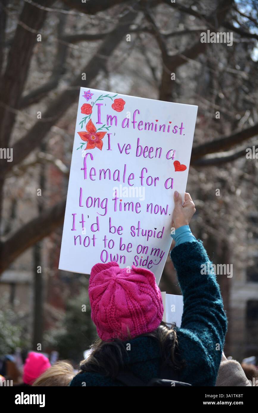 People holding signs at an International Women's Day march in New York ...