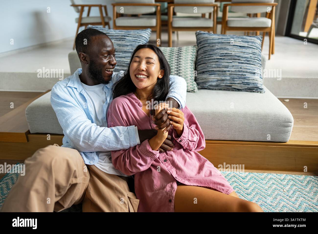 Joyful African-Asian couple embracing their diverse backgrounds ...