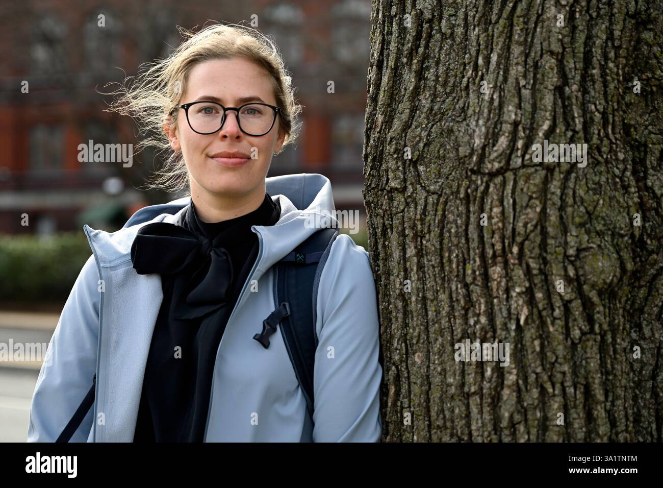 Sydney Smith, who lost her job due to DOGE cuts, stands in front of the ...