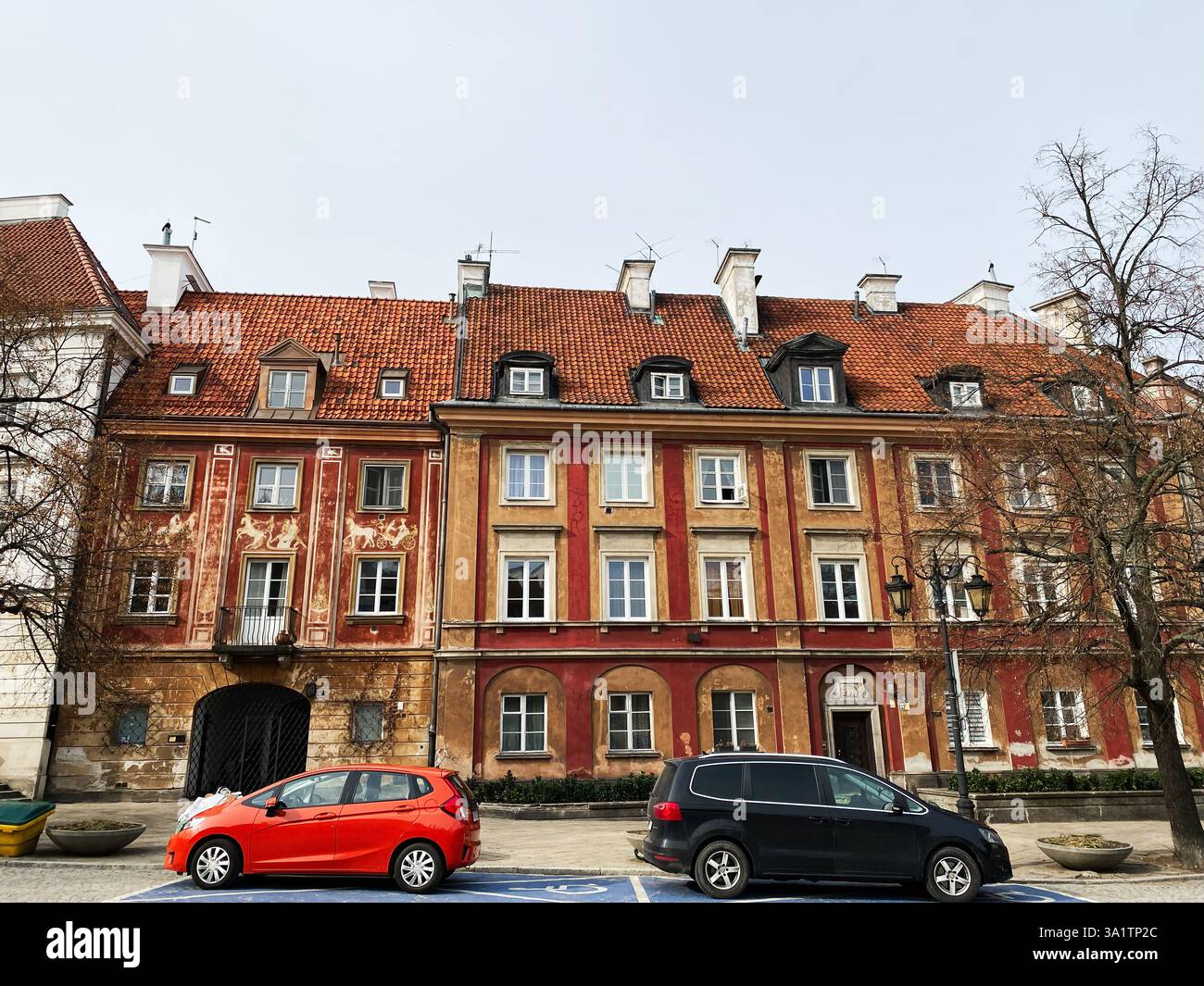 Charming historic buildings in Warsaw, Poland with cars parked on ...