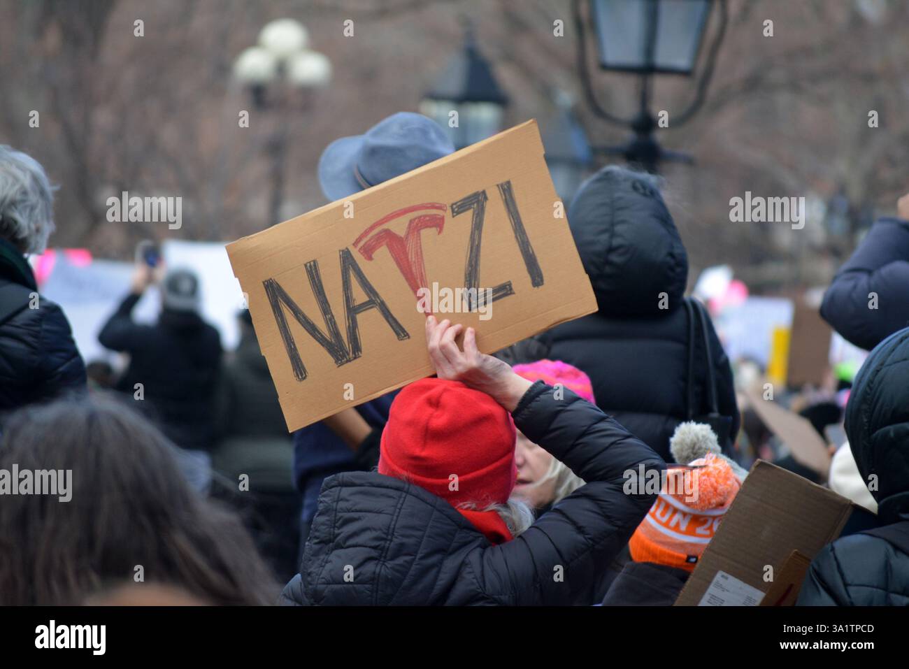 Anti-Tesla sign an International Women's Day event in Washington Square ...