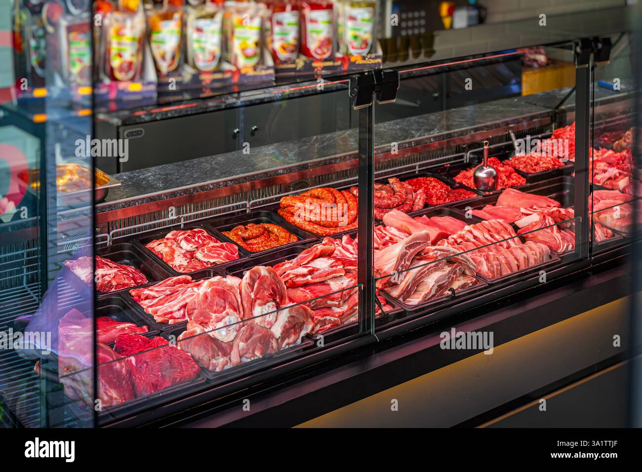 Meat counter. Butcher shop fridge counter with assortment of raw meat ...