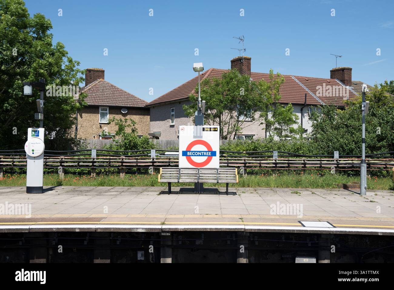 Empty Becontree station platform with way out sign and residential ...