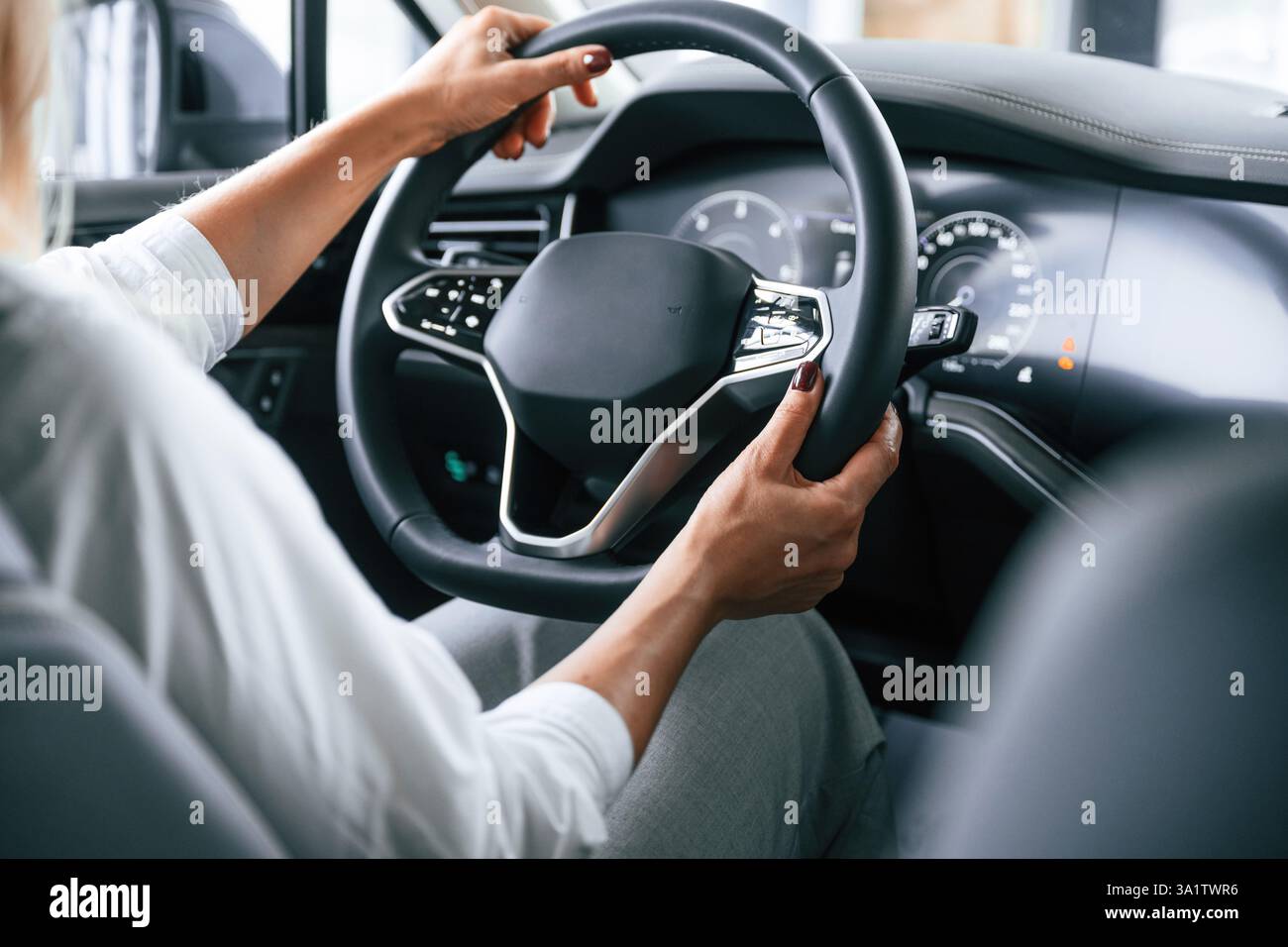 Modern quality interior. Woman is sitting in a car and driving it Stock ...