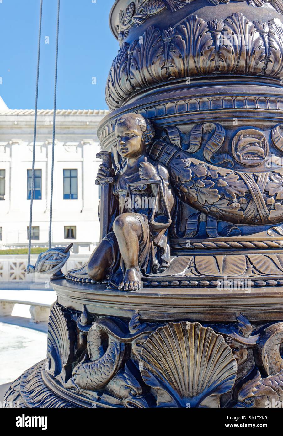 Detail: Bronze base of flagpole showing cherub holding sword ...