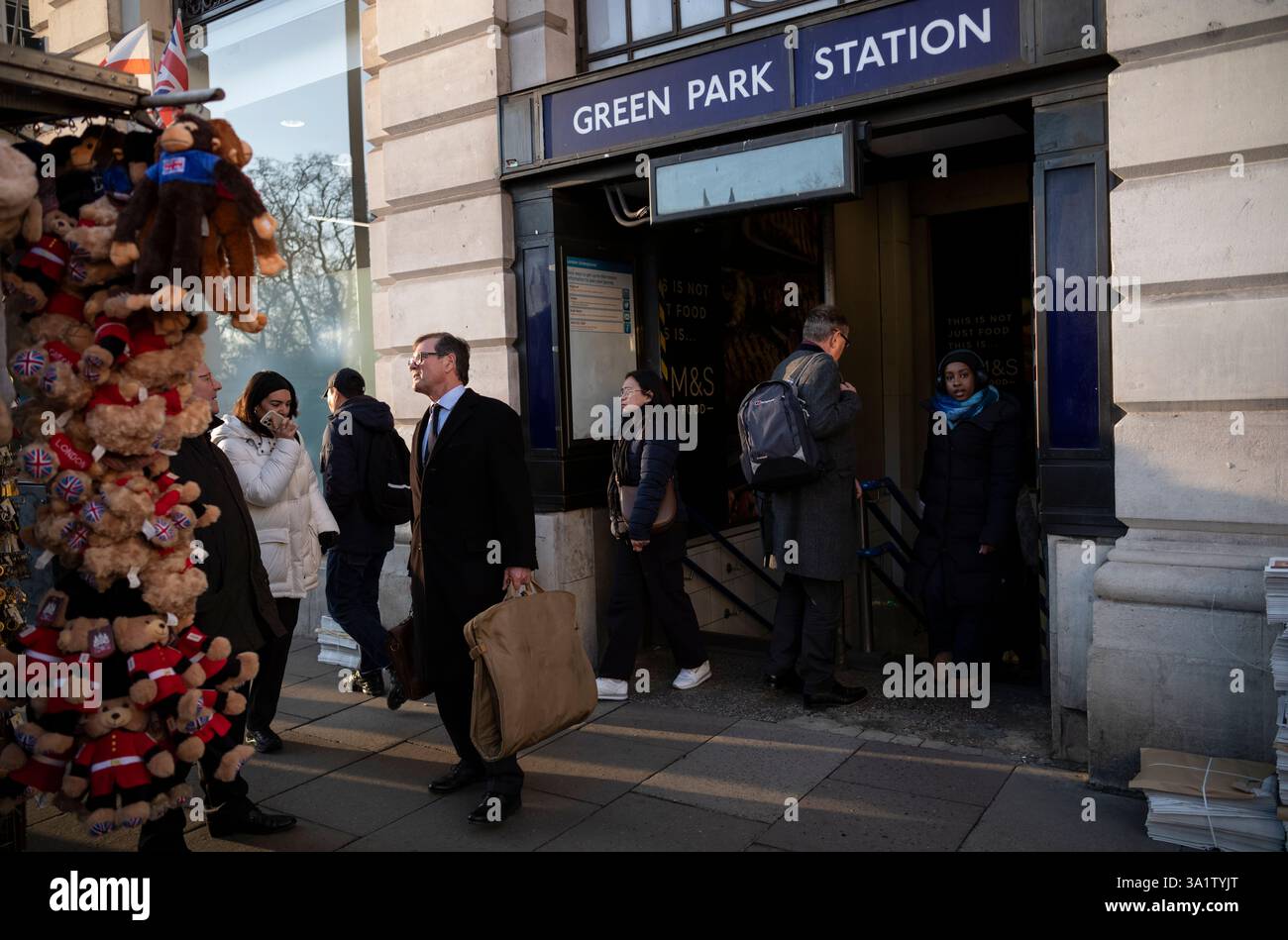 Businessmen go about their lives outside Green Park Underground Station ...