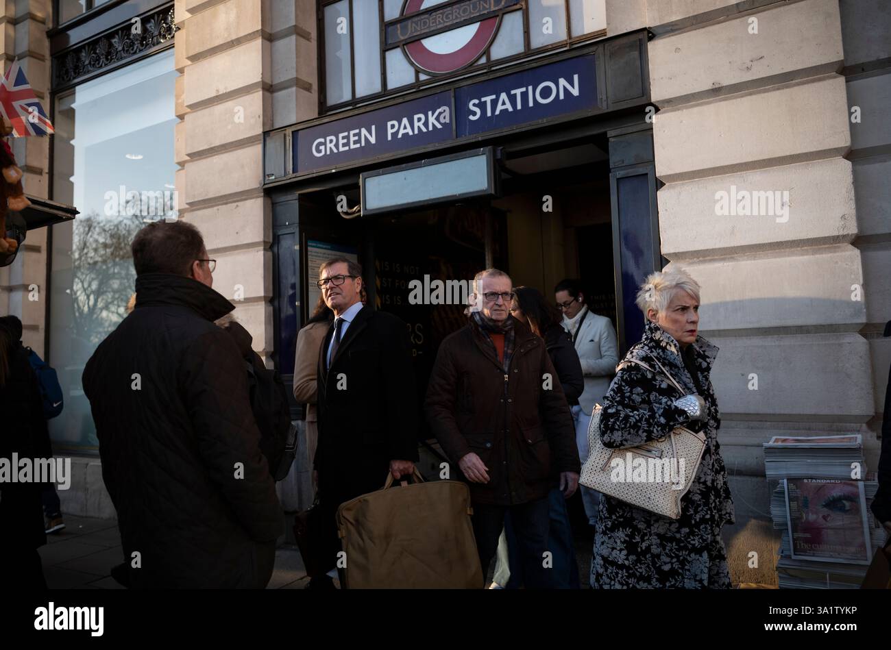 Businessmen go about their lives outside Green Park Underground Station ...