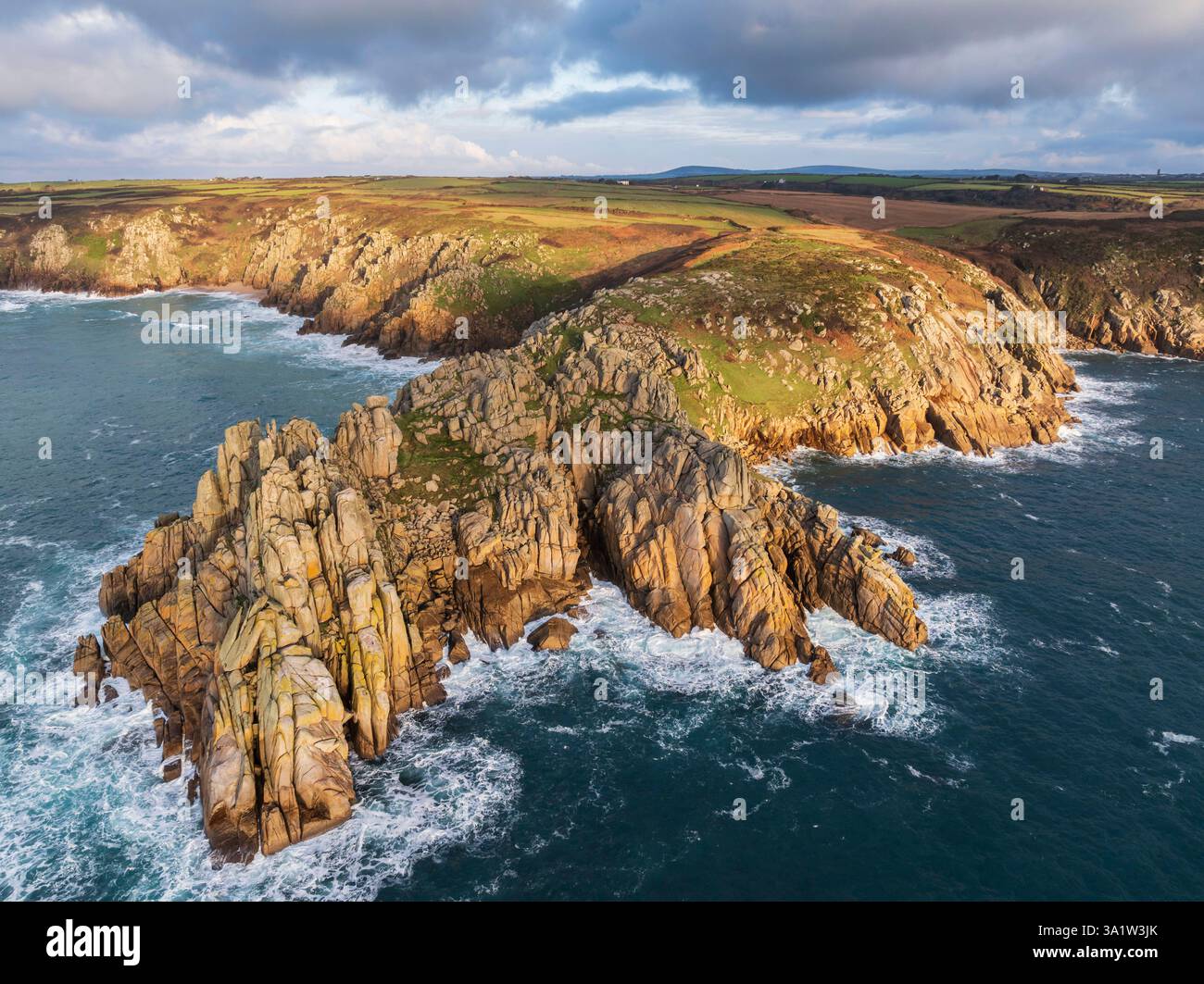 Aerial view of Treryn Dinas headland and Logan Rock near Porthcurno on ...