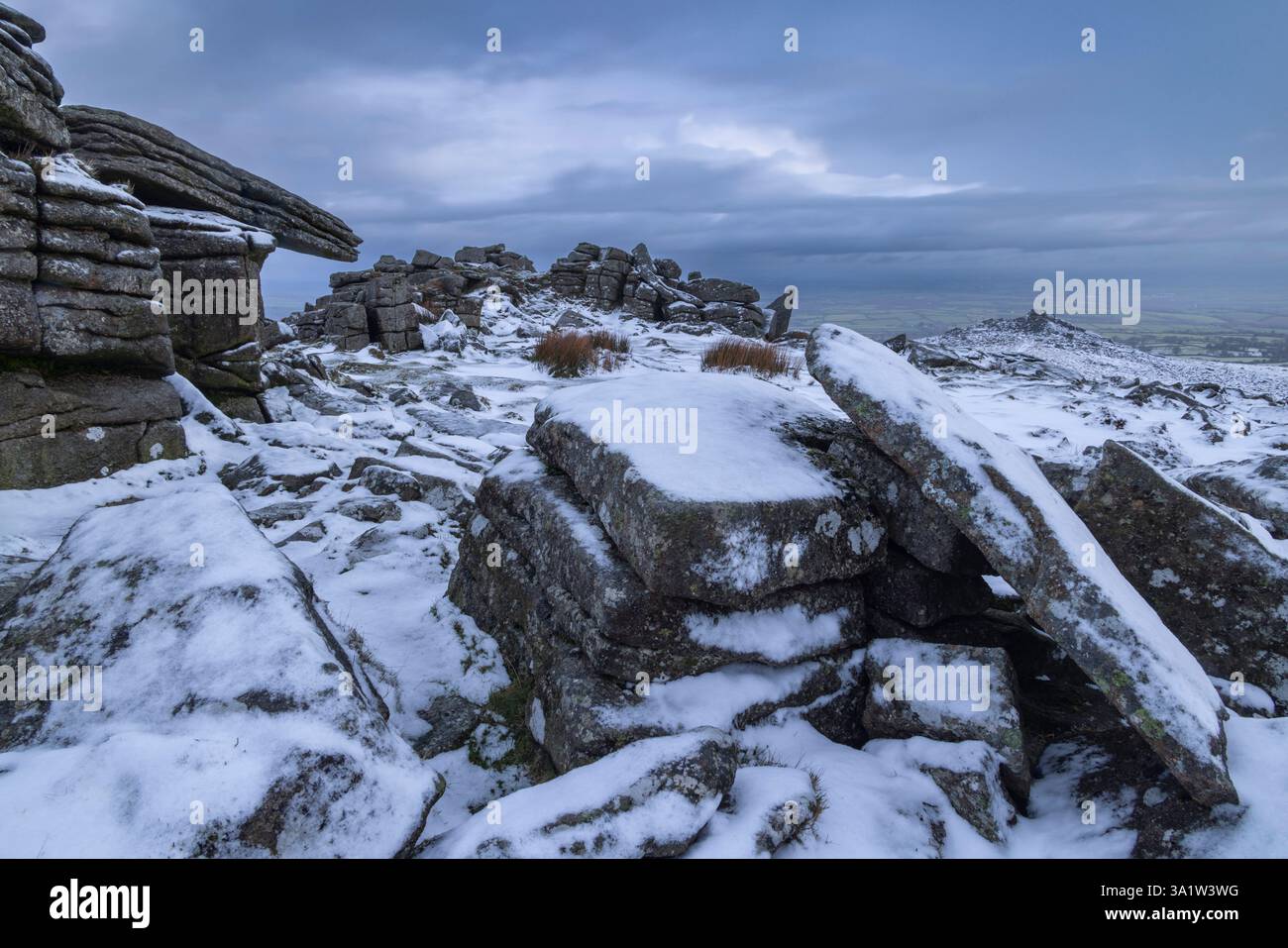 Snow covered granite outcrop on Belstone Tor, Dartmoor National Park ...