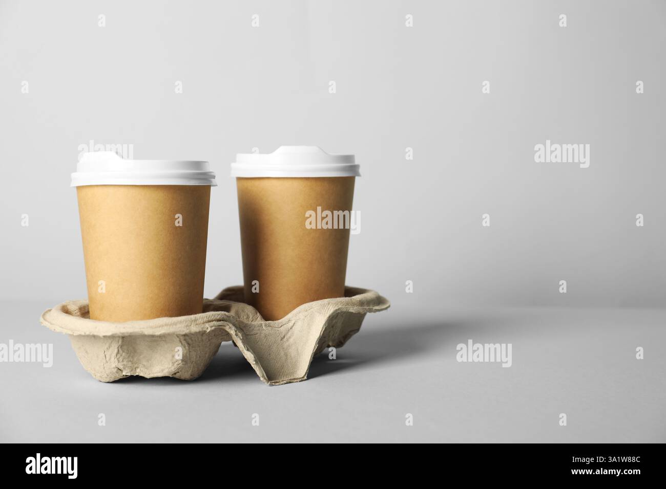 Paper cups with lids on grey background. Mockup for design Stock Photo ...