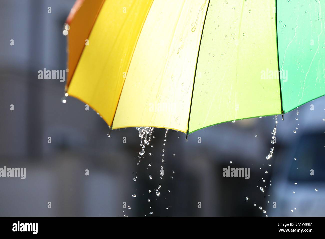 Open bright umbrella under pouring rain outdoors, closeup Stock Photo ...
