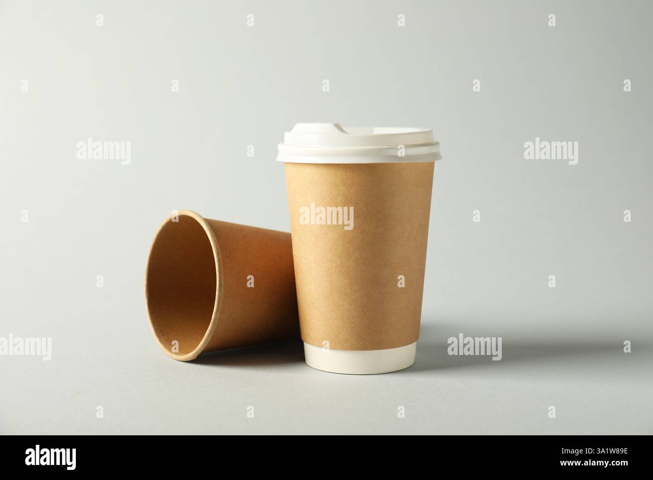 Paper cups with lids on grey background. Mockup for design Stock Photo ...