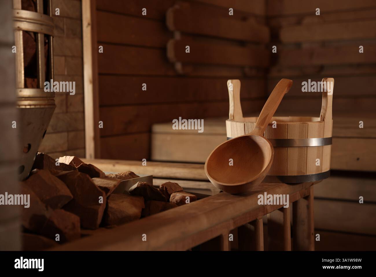 Bucket, ladle and stove with hot rocks in sauna Stock Photo - Alamy