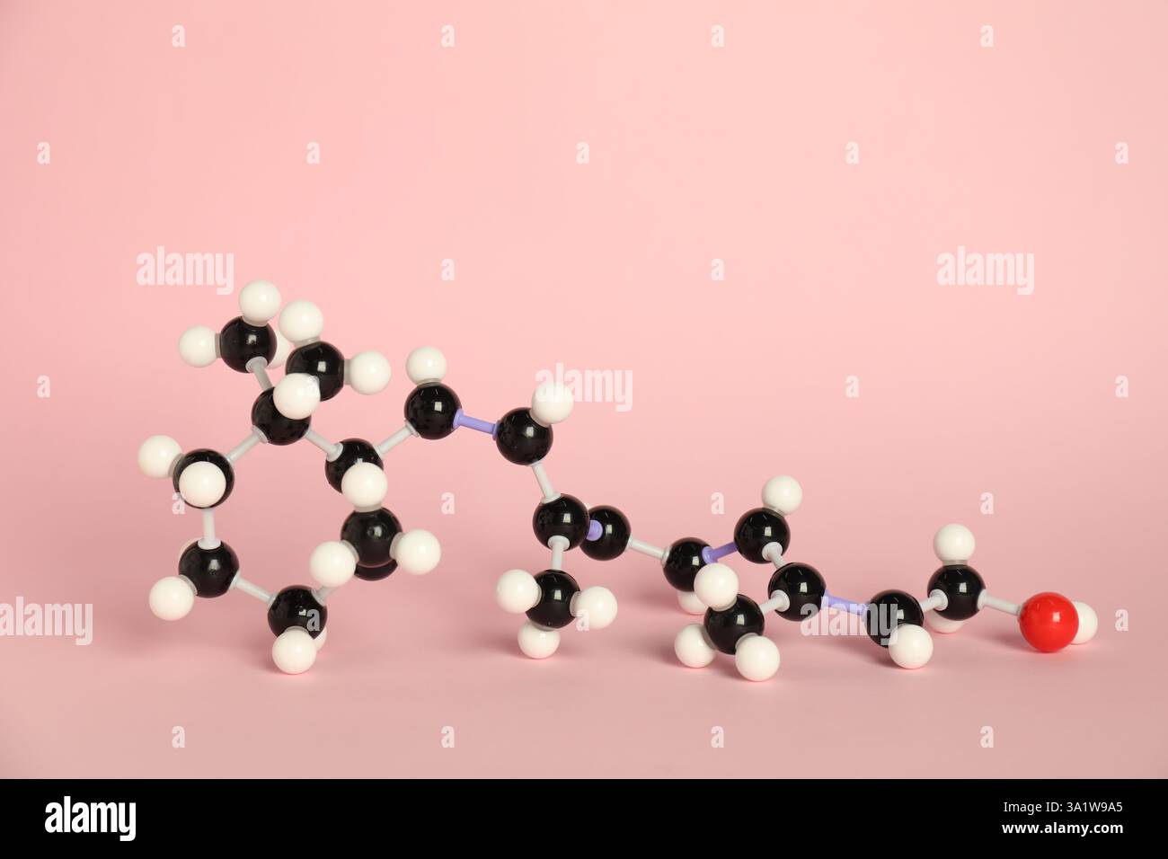 Molecule of retinol (vitamin A) on pink background. Chemical model ...