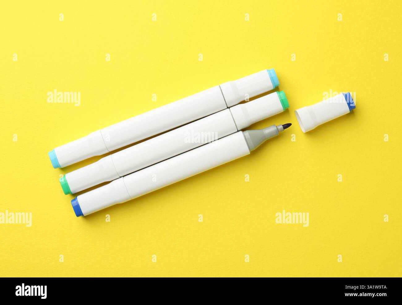 Colorful double sided markers on yellow background, flat lay Stock ...
