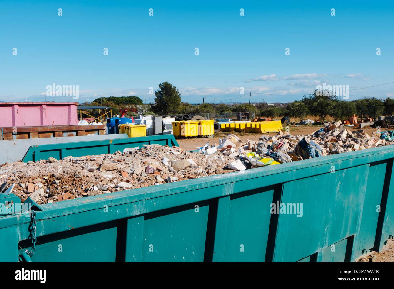 construction and demolition debris in a large waste container at a ...