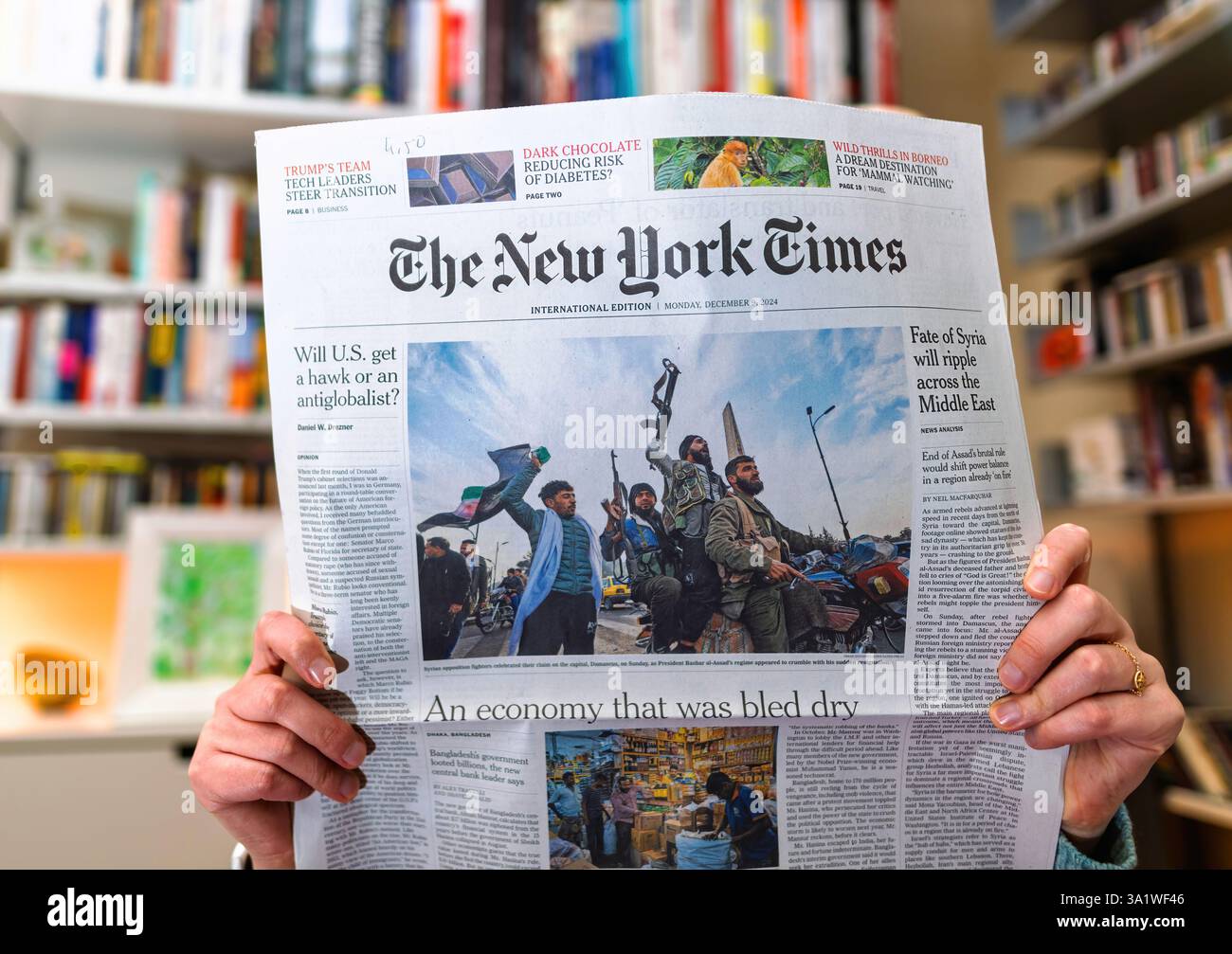Paris, France - Dec 9, 2024: woman reading NYT newspaper with global ...