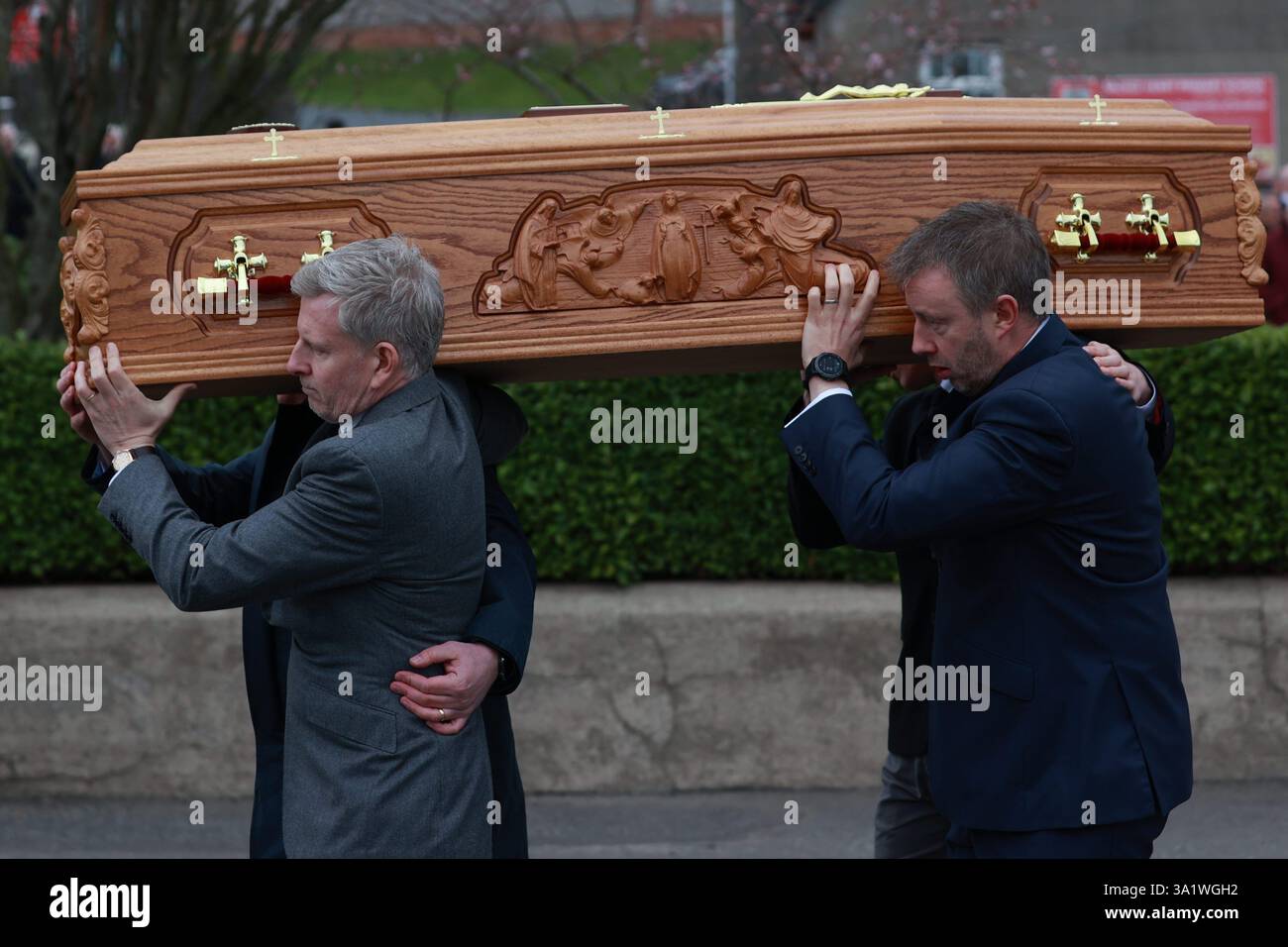 Patrick Kielty (left) carries the coffin of his mother Mary Kielty ...