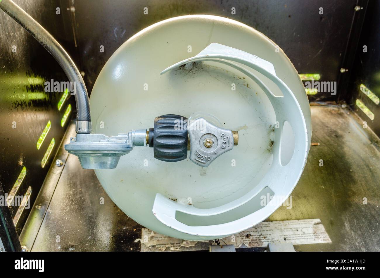 top view of BBQ propane tank and regulator inside a barbecue Stock Photo - Alamy