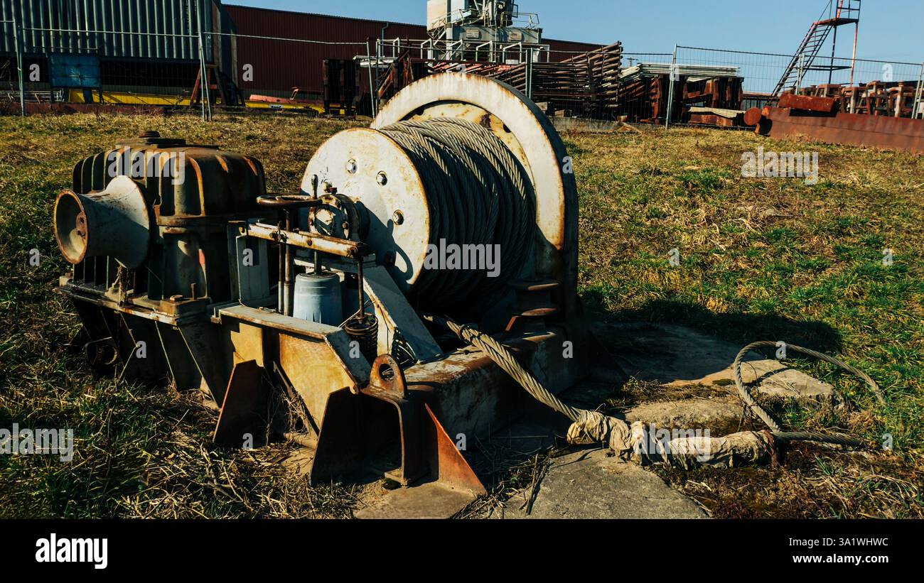 Rusty industrial winch with thick steel cables in an abandoned ...