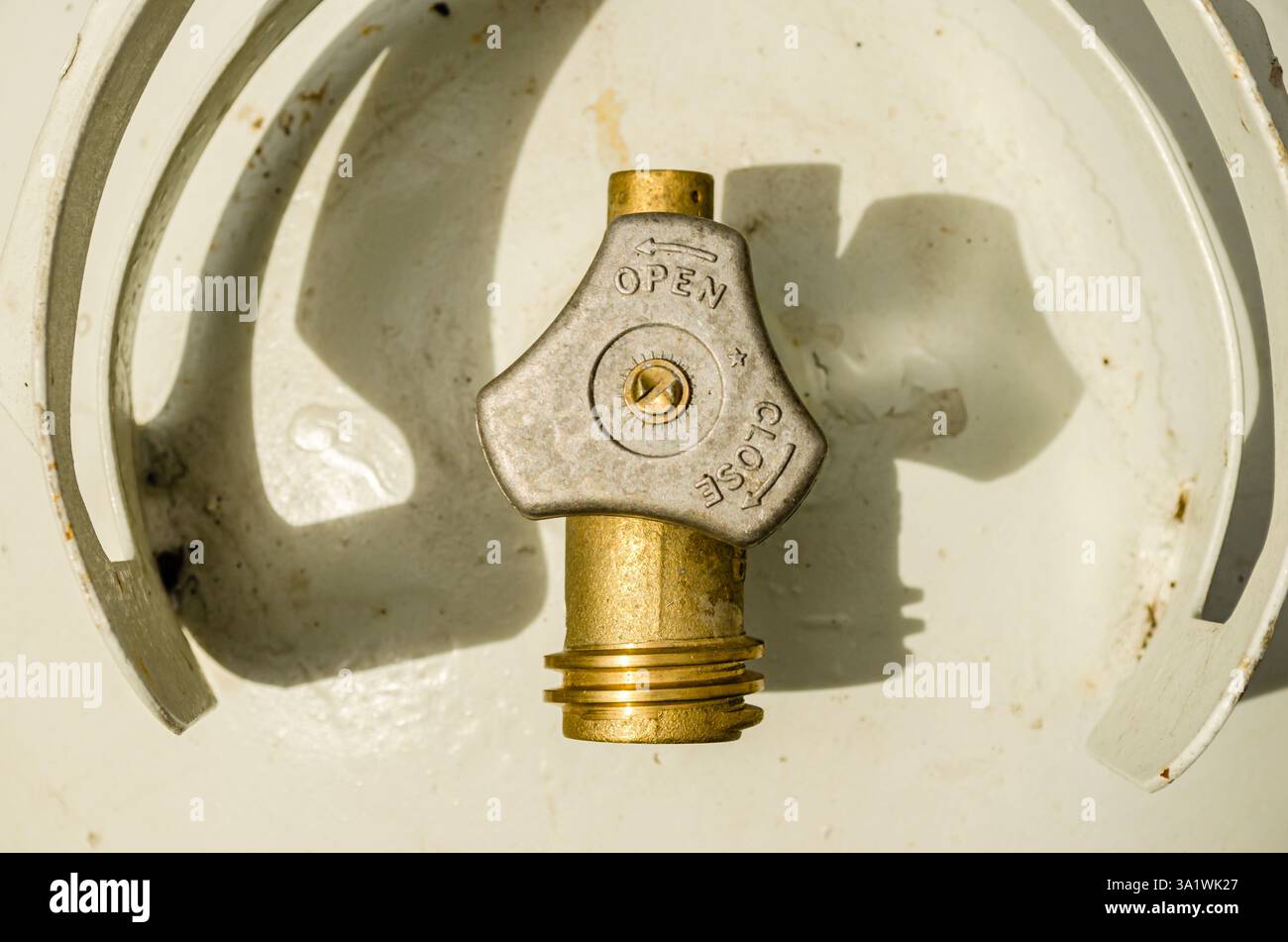 Overhead close-up of a white propane tank and brass valve Stock Photo ...