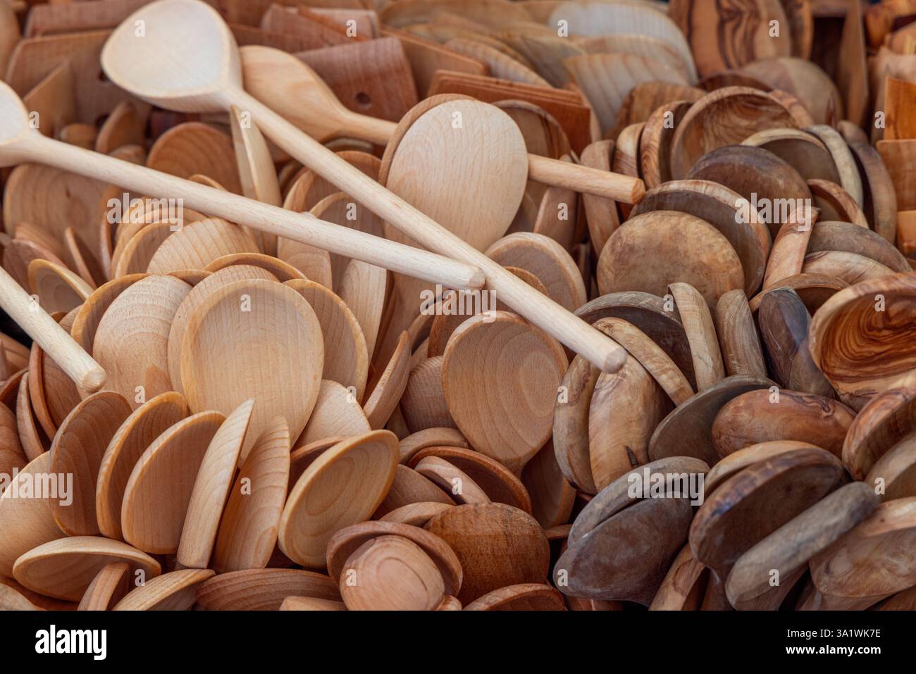 Close-up of stacked wooden spoons and utensils made from different wood ...