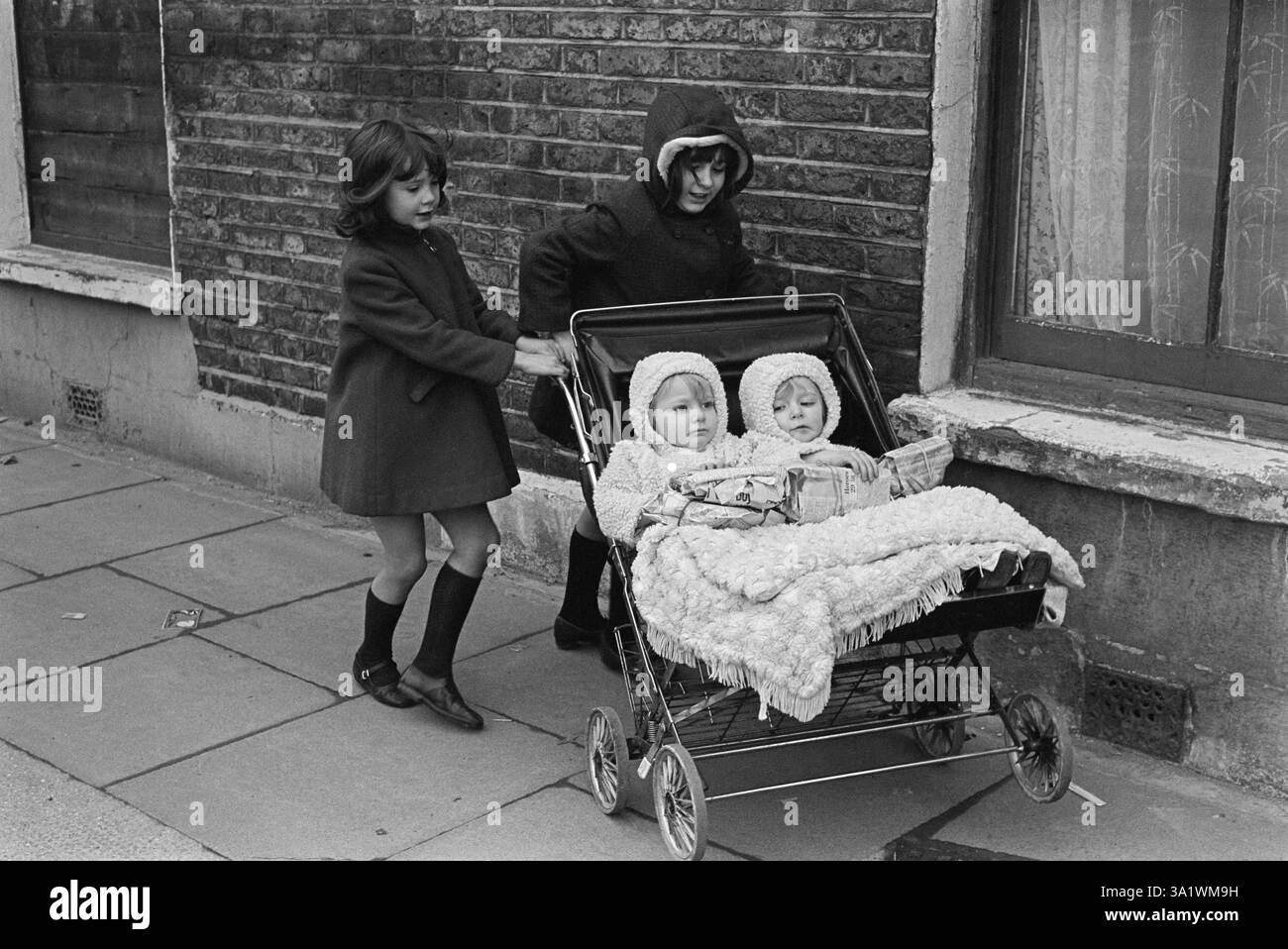 Farthing Bundles, Fern Street Settlement, London 1970s UK. Sisters with ...