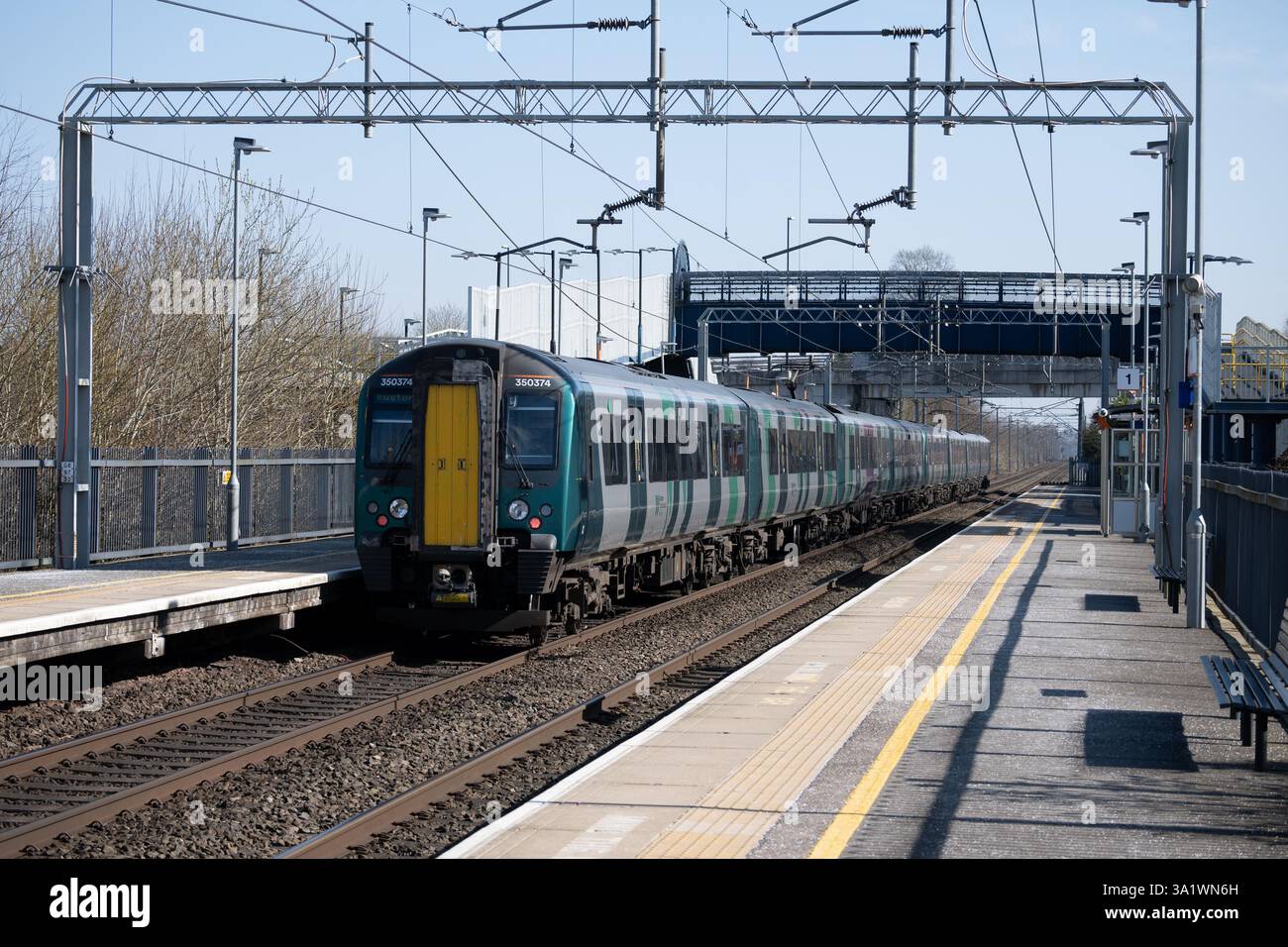 A London Northwestern Railway class 350 electric train at Tile Hill station, Coventry, West ...