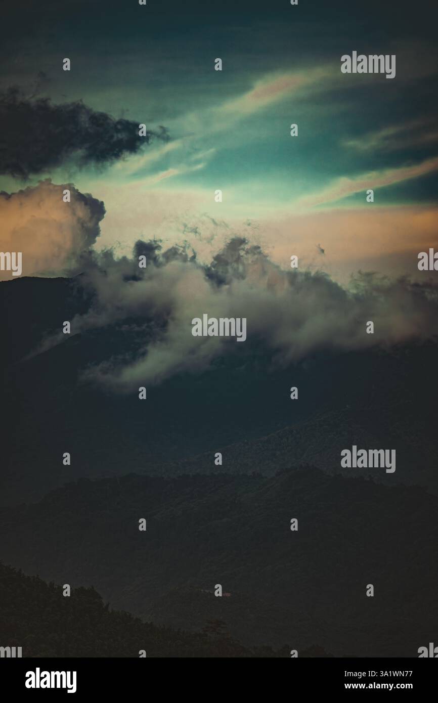 vintage style photo of a lonely cloud within a shadowy mountain range ...