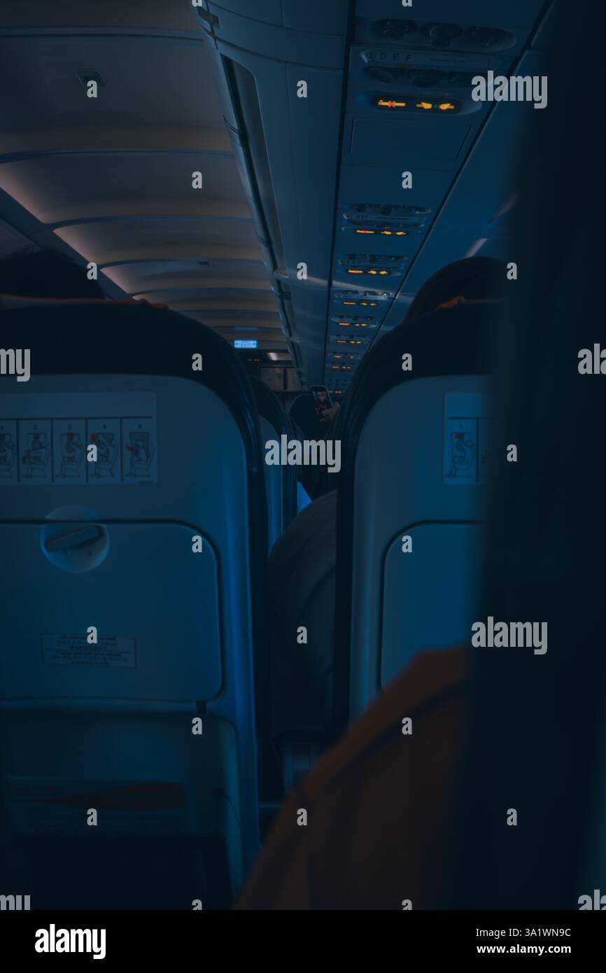 Inside the airplane during the flight, looking down the aisle between ...