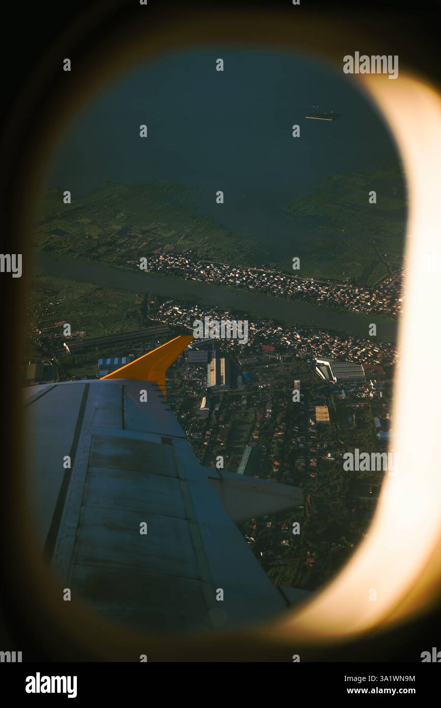View of a city in the Philippines through the airplane window during a ...