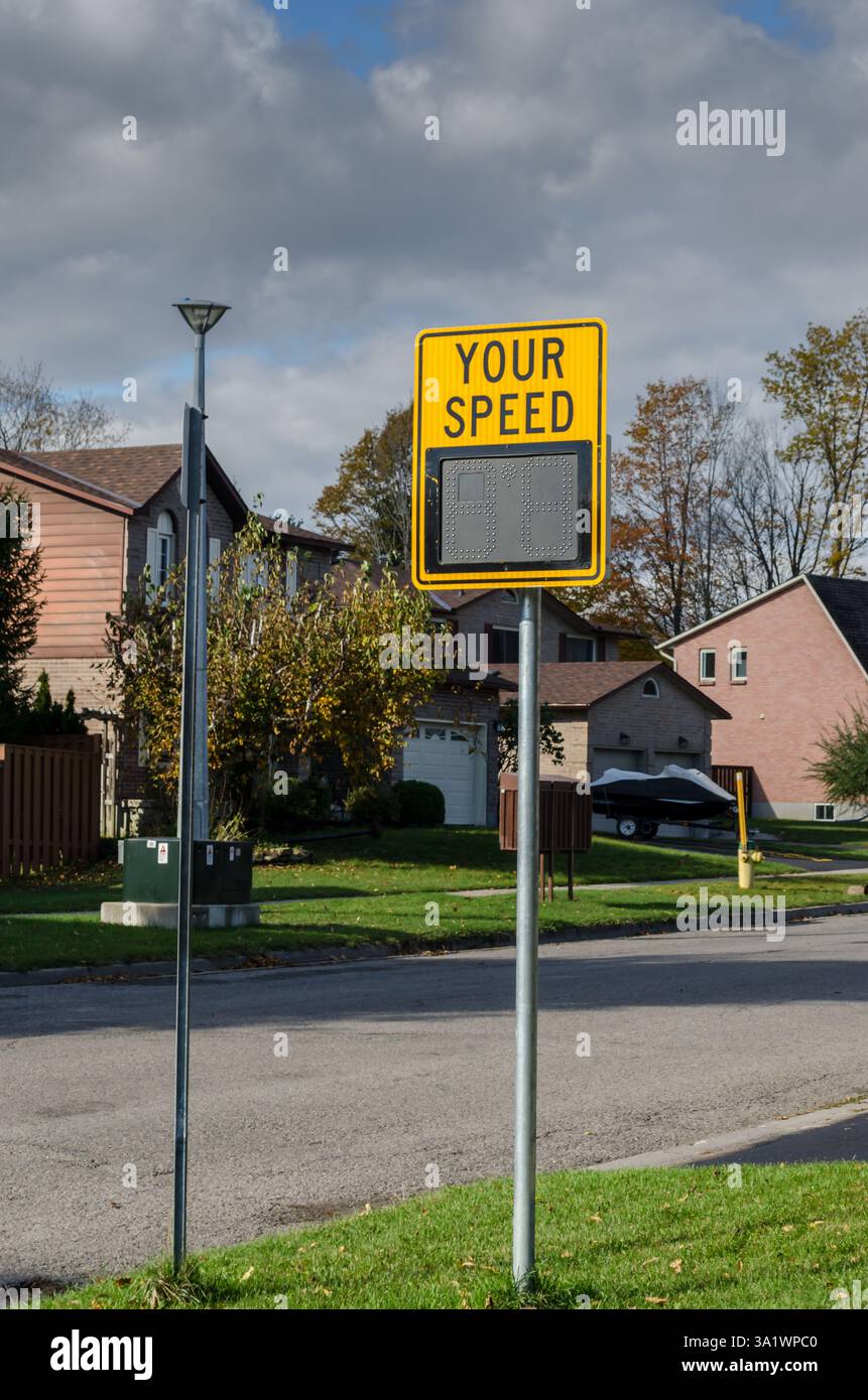 Yellow speed caution radar sign in a residential neighborhood Stock ...
