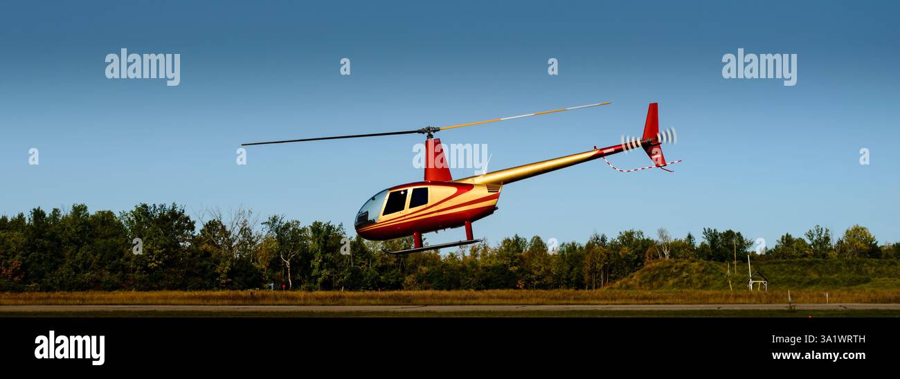 Panorama off a helicopter taking off above a rural runway with a clear ...