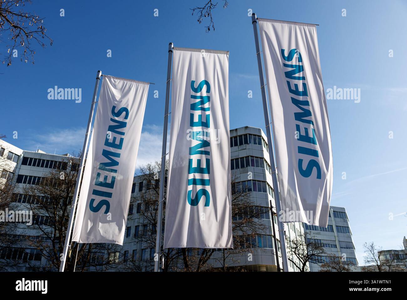 Munich, Germany. 09th Mar, 2025. The Siemens lettering and logo can be seen on flags in front of ...