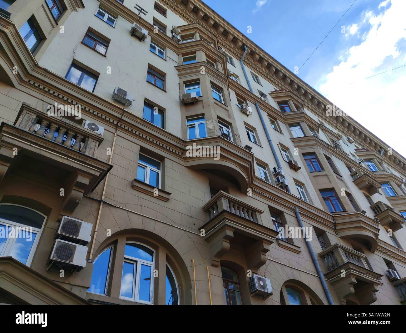An aged apartment building with intricate details overshadowed by ...