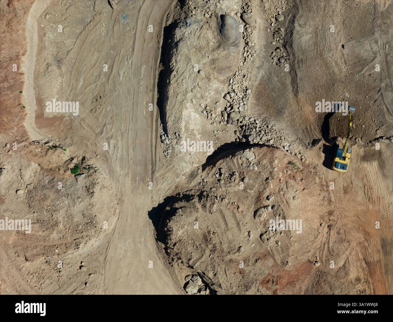 Heavy machinery busy reshaping landscape at construction site under ...