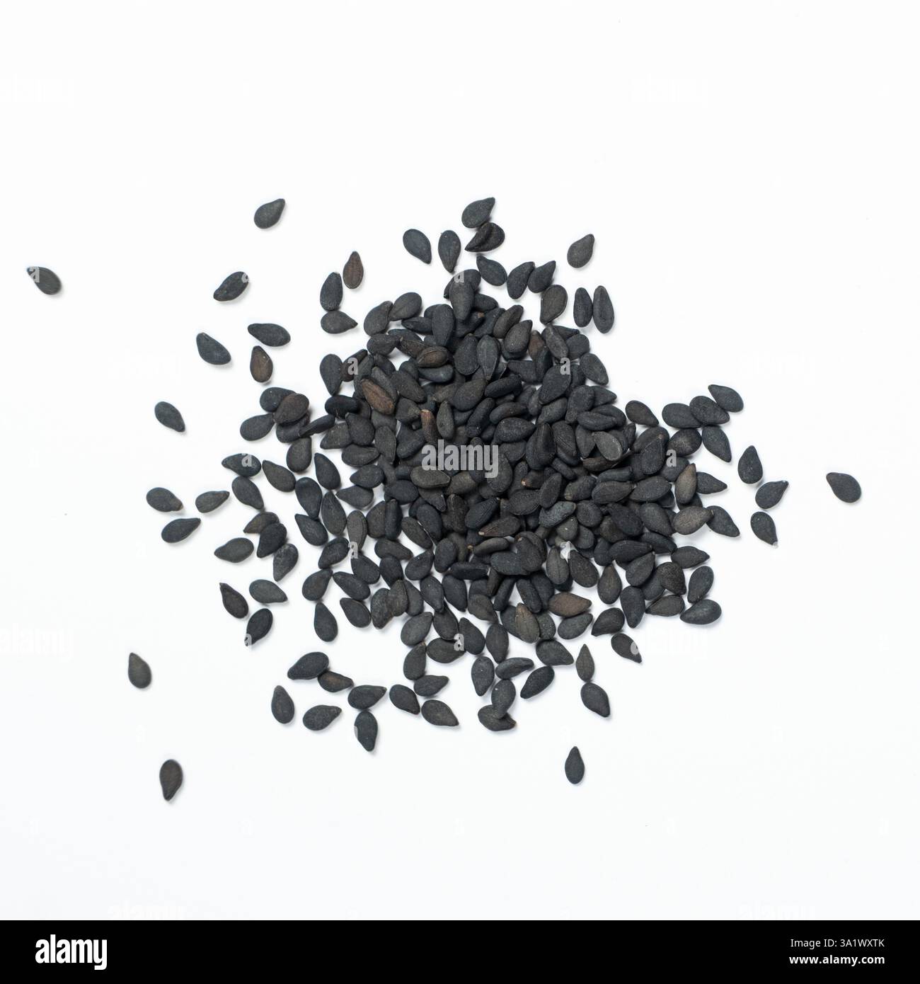 Black sesame seeds scattered on a white background macro top view Stock ...