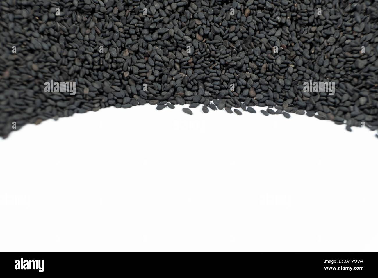 Black sesame seeds scattered on a white background place for text Stock ...