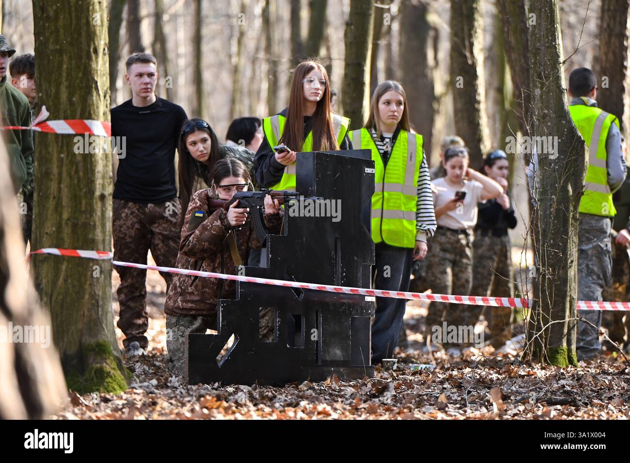 Non Exclusive: A girl in the kneeling position shoots a rifle during a ...