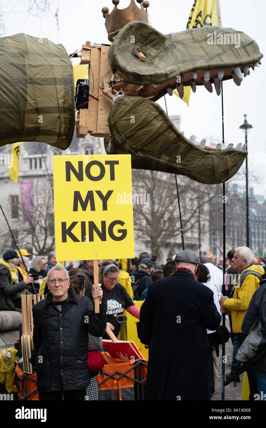 London, UK. 10 March, 2025. A 15ft tall dinosaur puppet wearing a crown ...