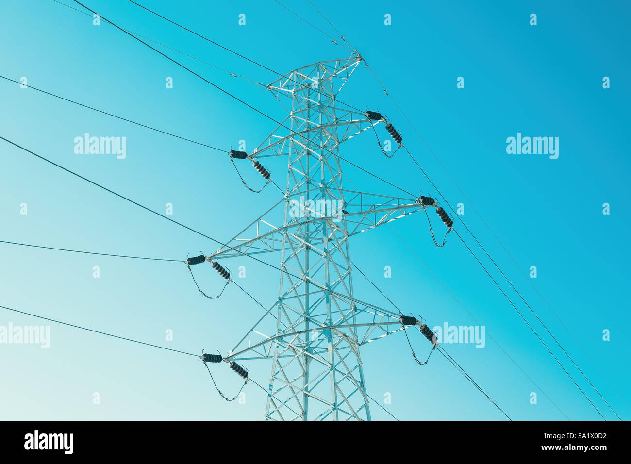 Electricity pylon with overhead powerline cables against cloudy sky ...