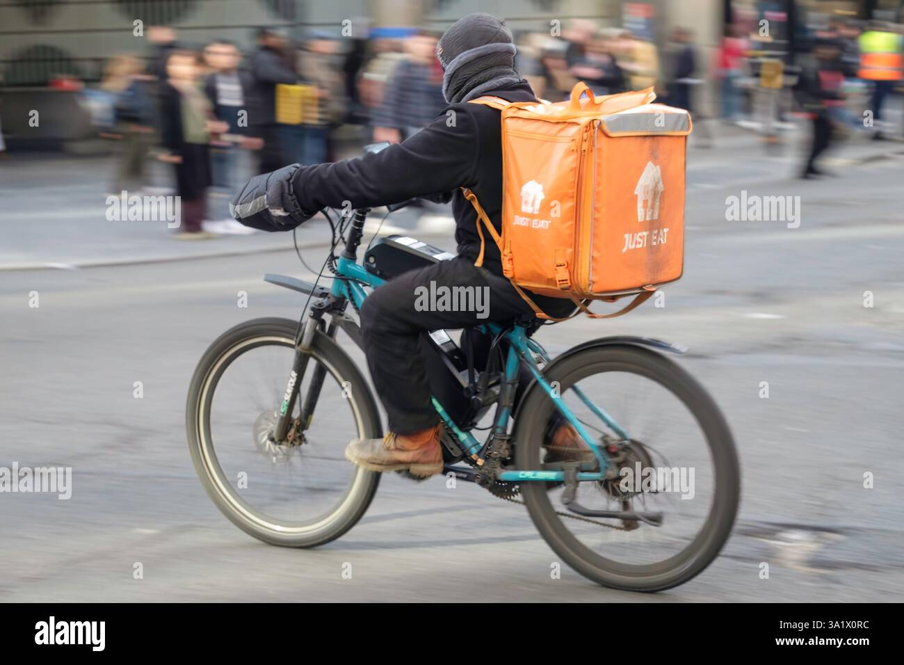 A Just Eat courier on e-bike on central London street, UK Stock Photo ...