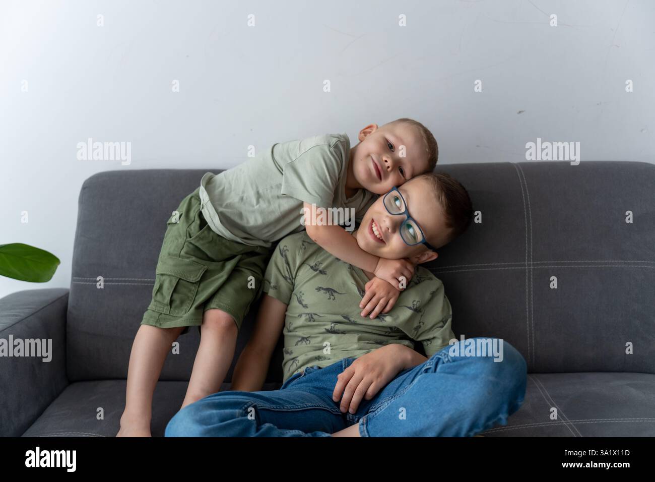 Brothers hug, kiss each other on the cheek and laugh. Family relationships. Friendship and love ...