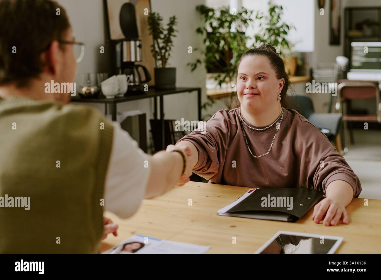Over shoulder view of unrecognizable job interviewer shaking hands with ...