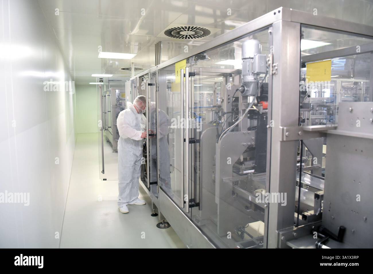 medical products manufacturing in a modern factory - worker operates ...