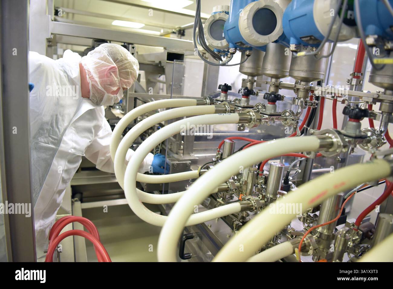 medical products manufacturing in a modern factory - worker operates ...