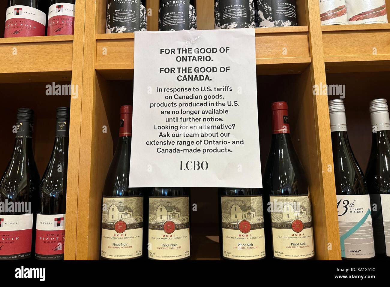 A sign is posted on a wine shelves at an LCBO, the government-run ...