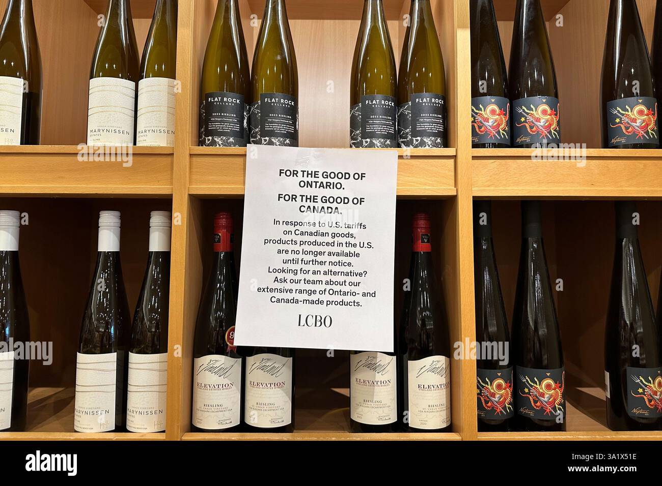A sign is posted on a wine shelves at an LCBO, the government-run ...