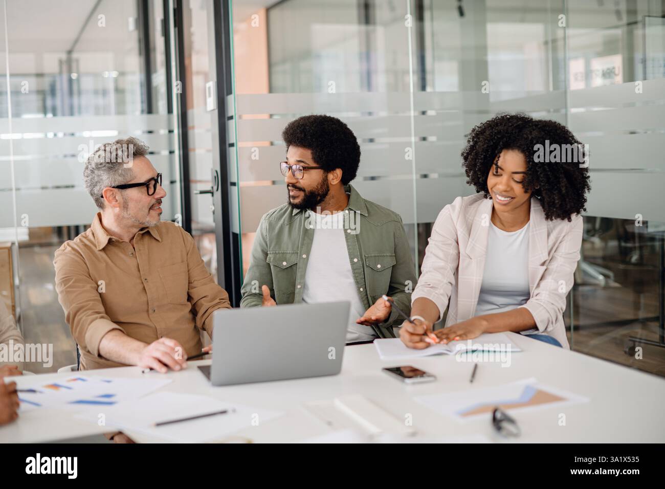 A team collaborating on innovative ideas in a modern office environment ...